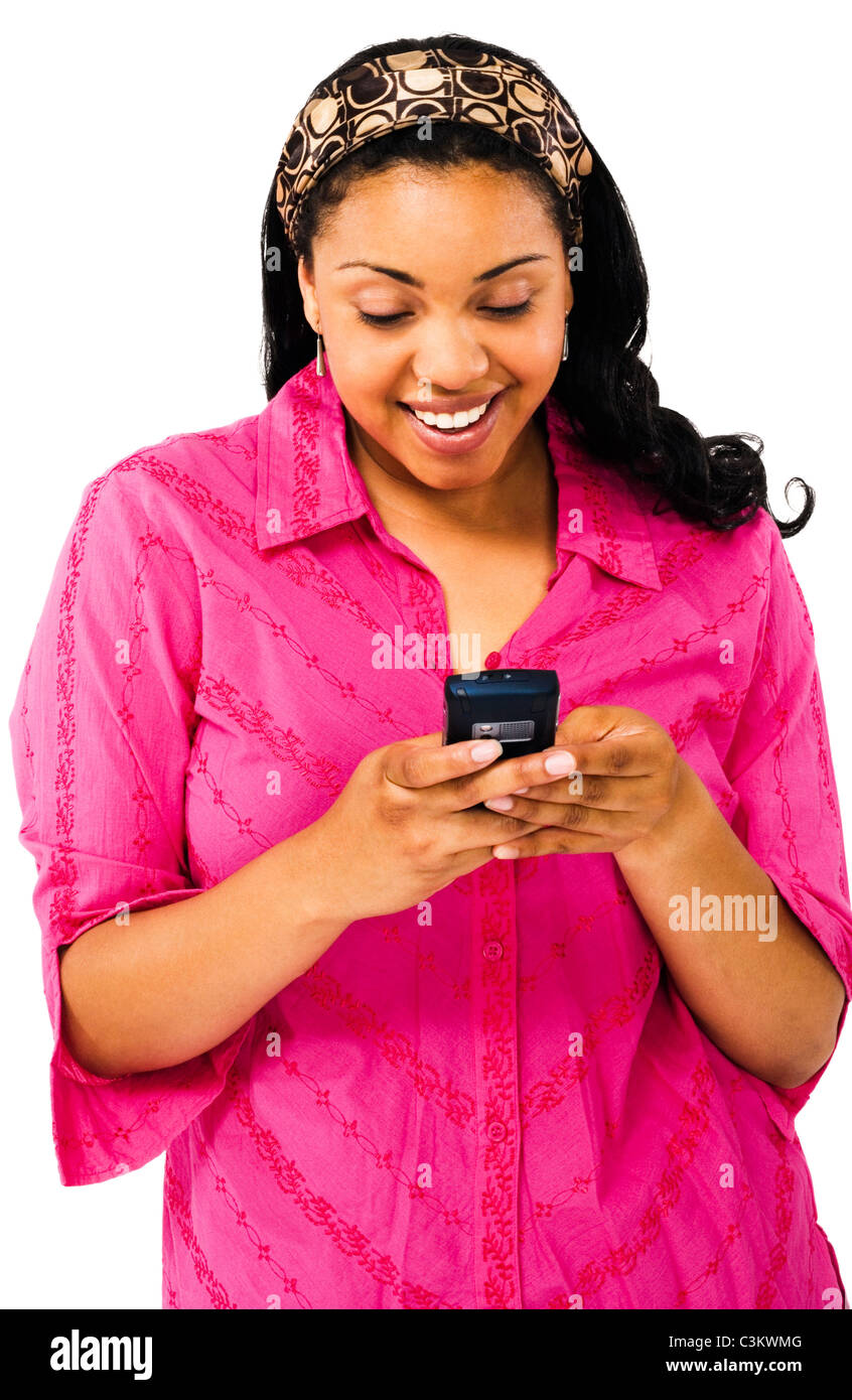 Woman text messaging on a mobile phone and smiling isolated over white ...