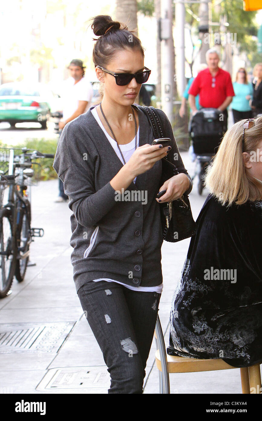 Jessica Alba making a phone call while walking to her parked car after ...