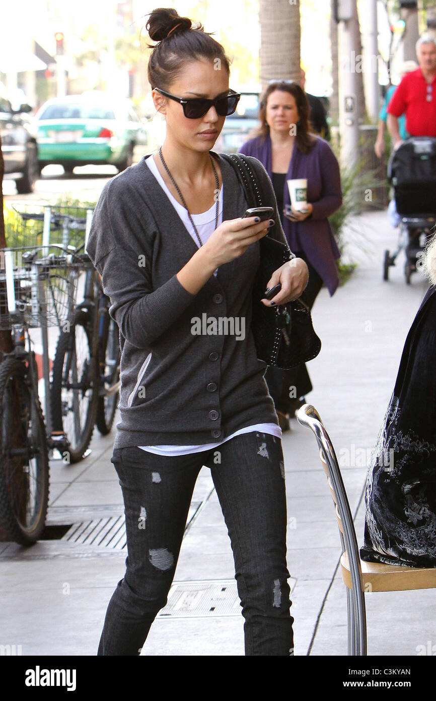 Jessica Alba making a phone call while walking to her parked car after ...