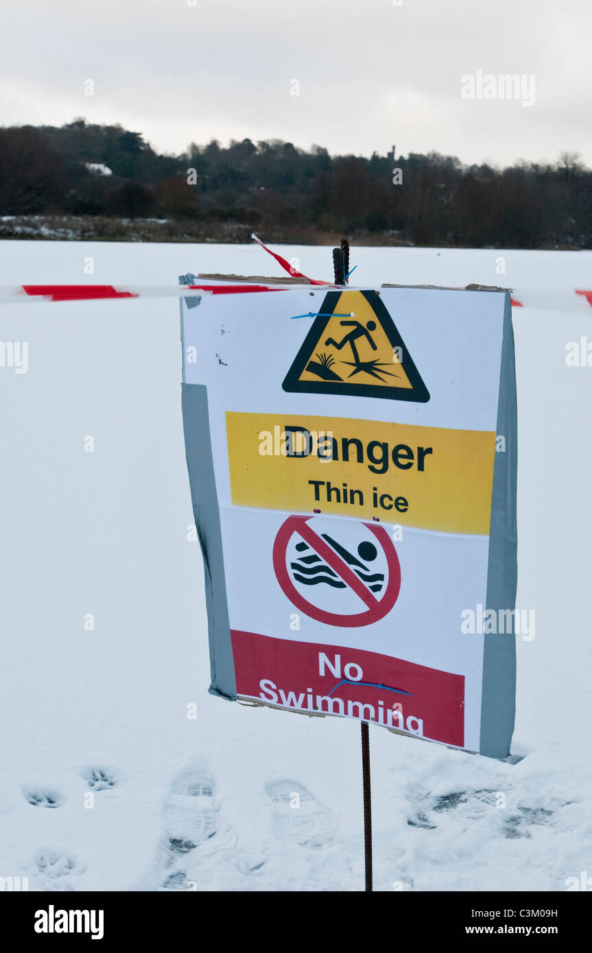 Danger Thin Ice signs over frozen water Stock Photo - Alamy