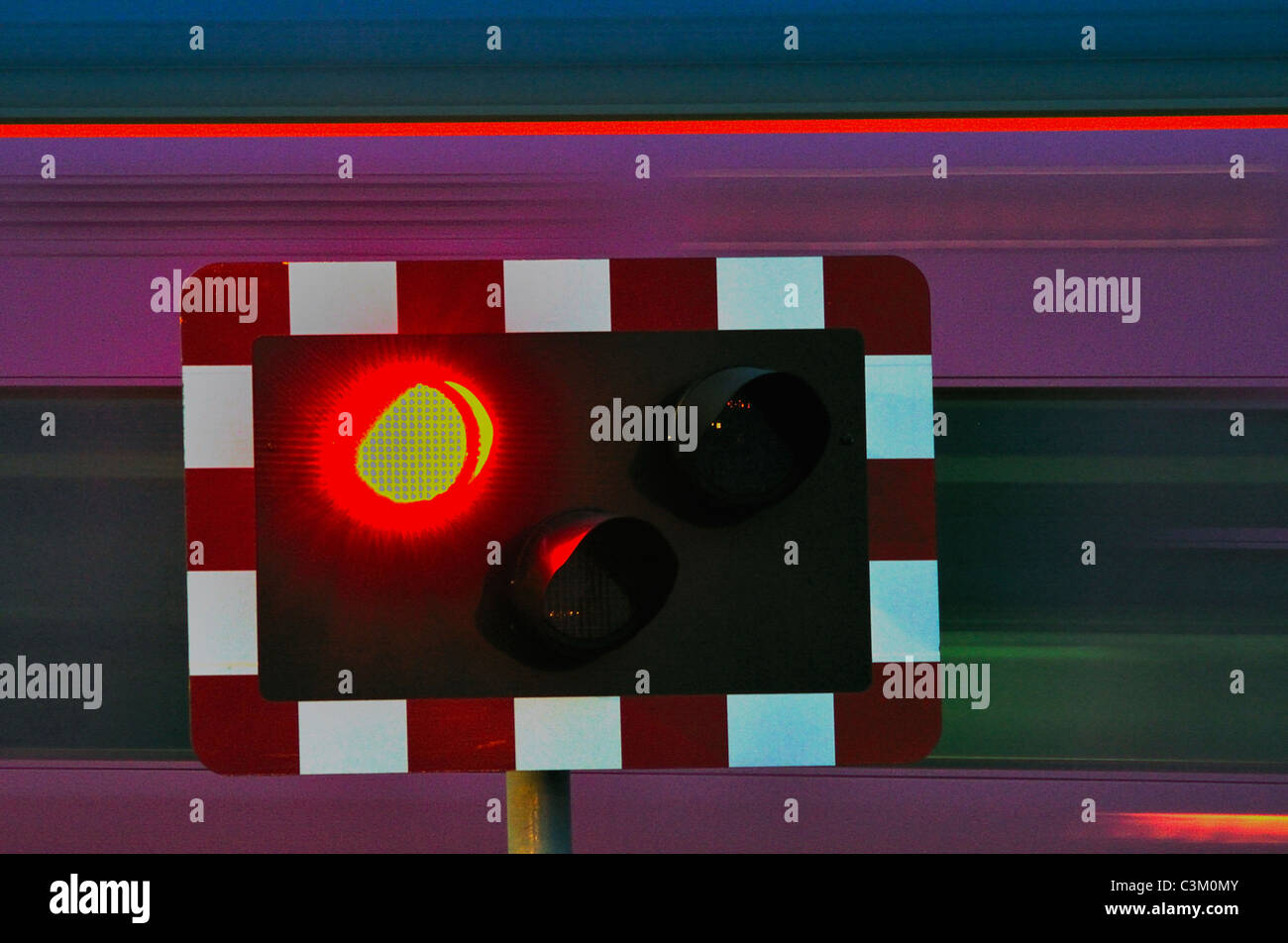 Speeding train passing a red stop light Stock Photo - Alamy