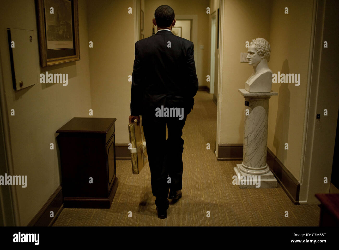 President Barack Obama walks through the West Wing of the White House ...