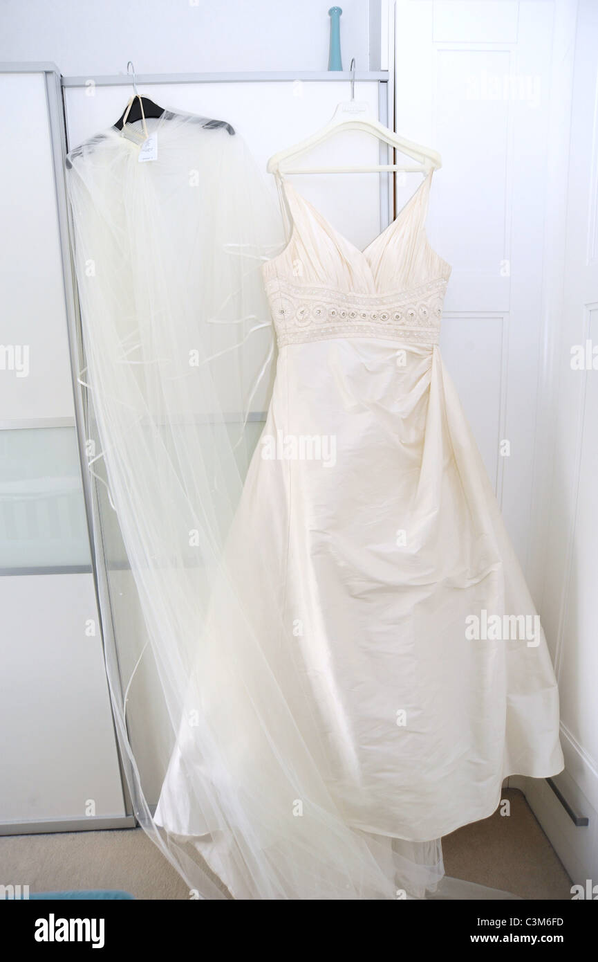 A wedding dress hanging up Stock Photo - Alamy