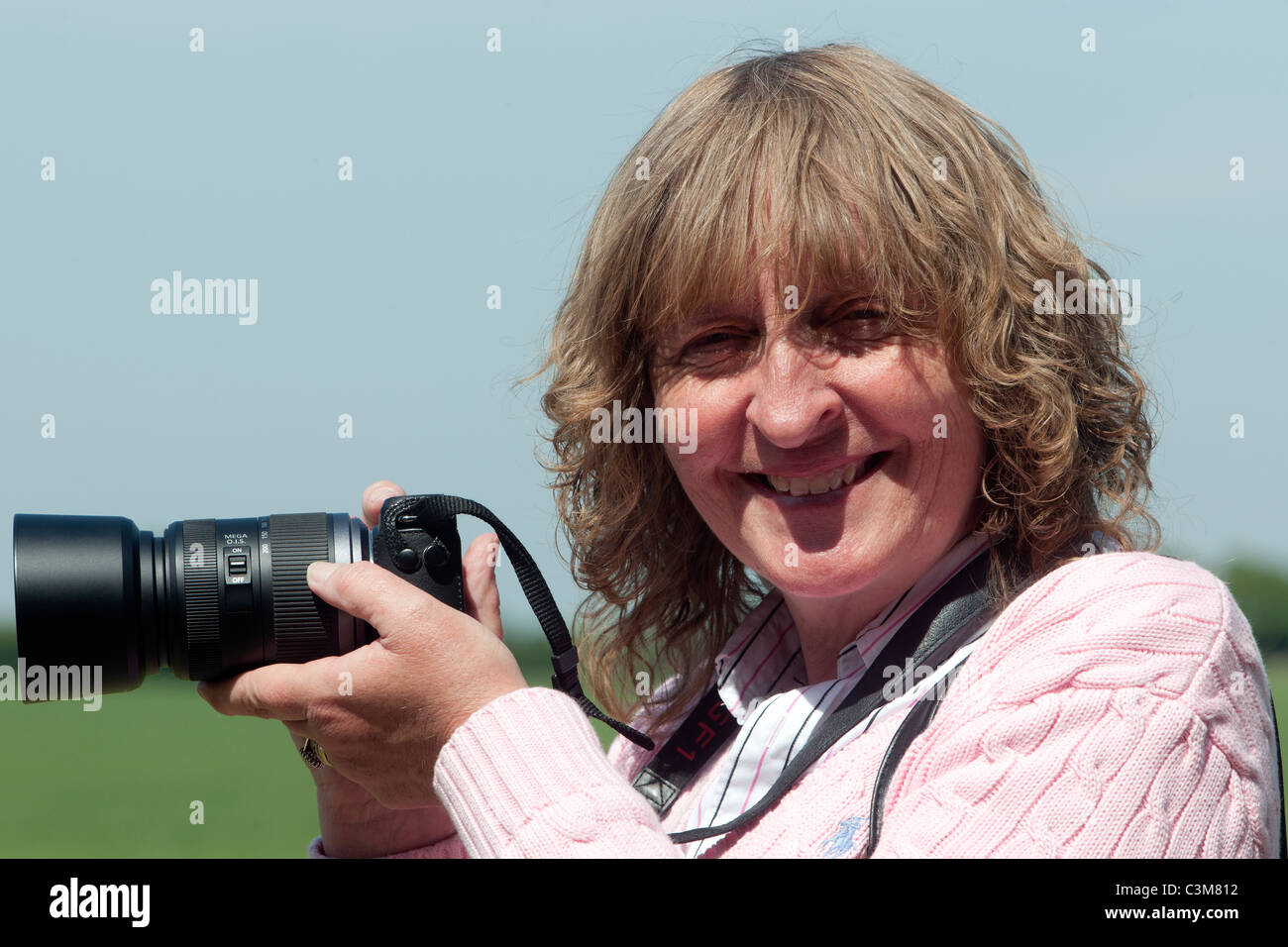 English lady using modern digital camera Stock Photo - Alamy