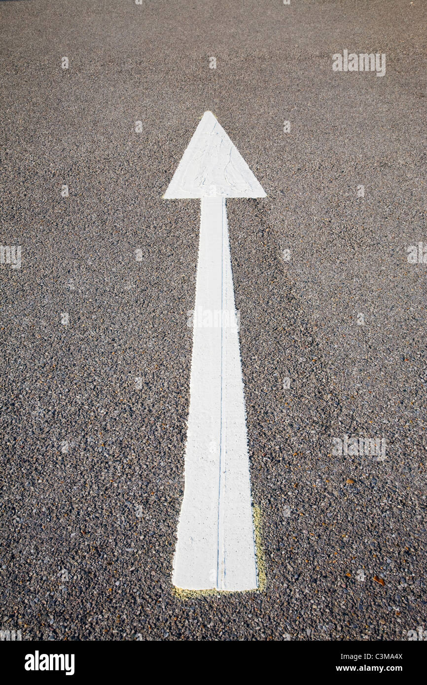 Straight ahead arrow on a road Stock Photo - Alamy