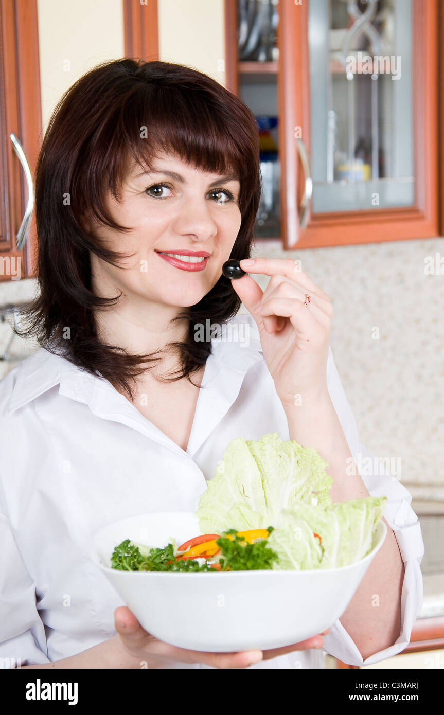 Beautiful a woman to taste cooked the food Stock Photo - Alamy