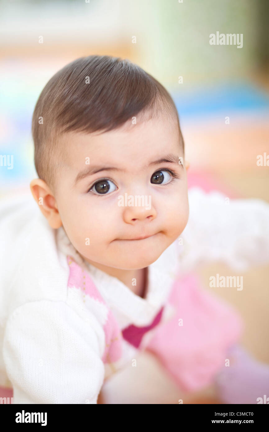 Bavaria, Baby girl crouching Stock Photo - Alamy