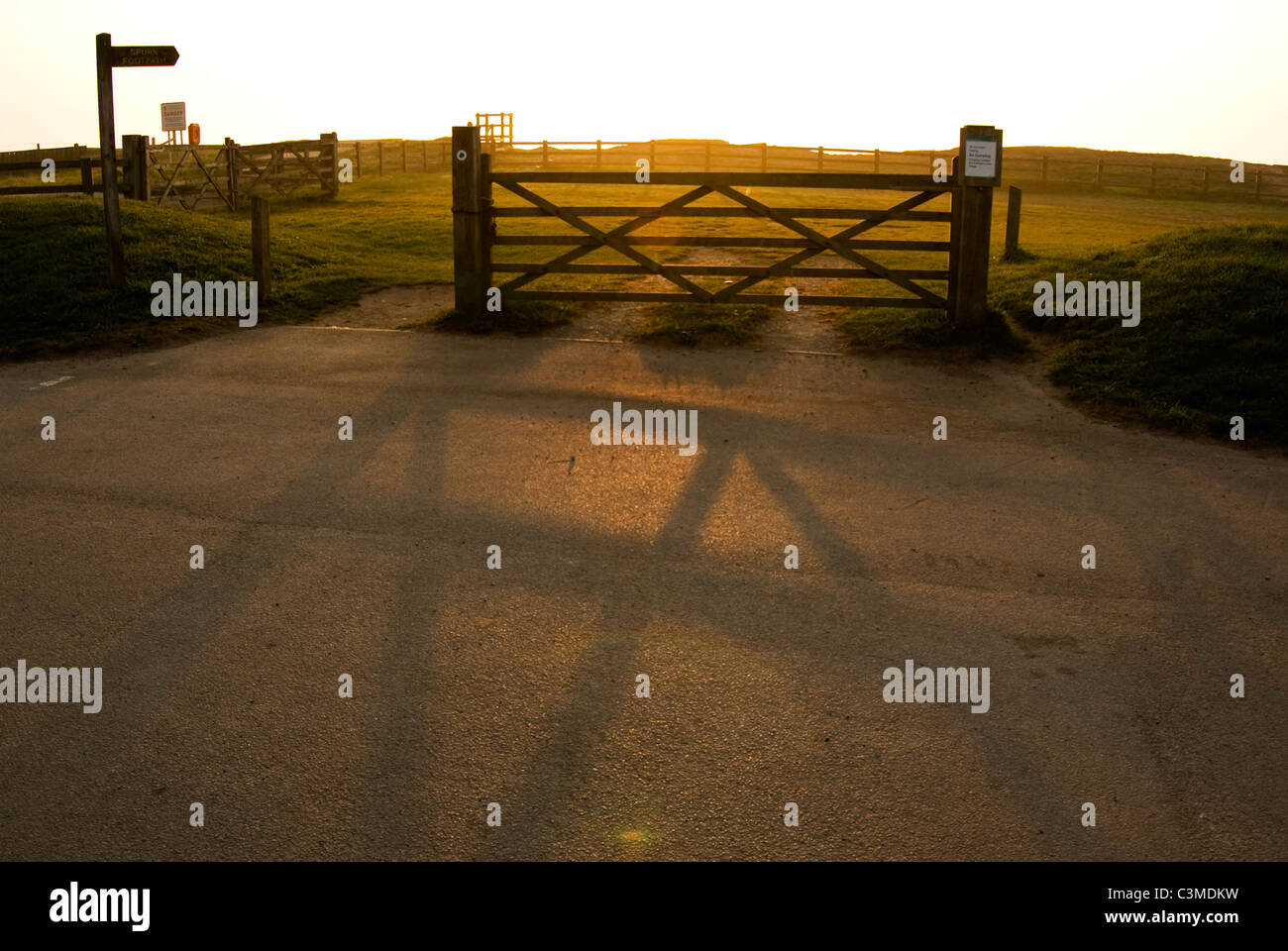 Gate to Kilnsea Beach in the rising sun, Kilnsea, East Yorkshire, UK ...
