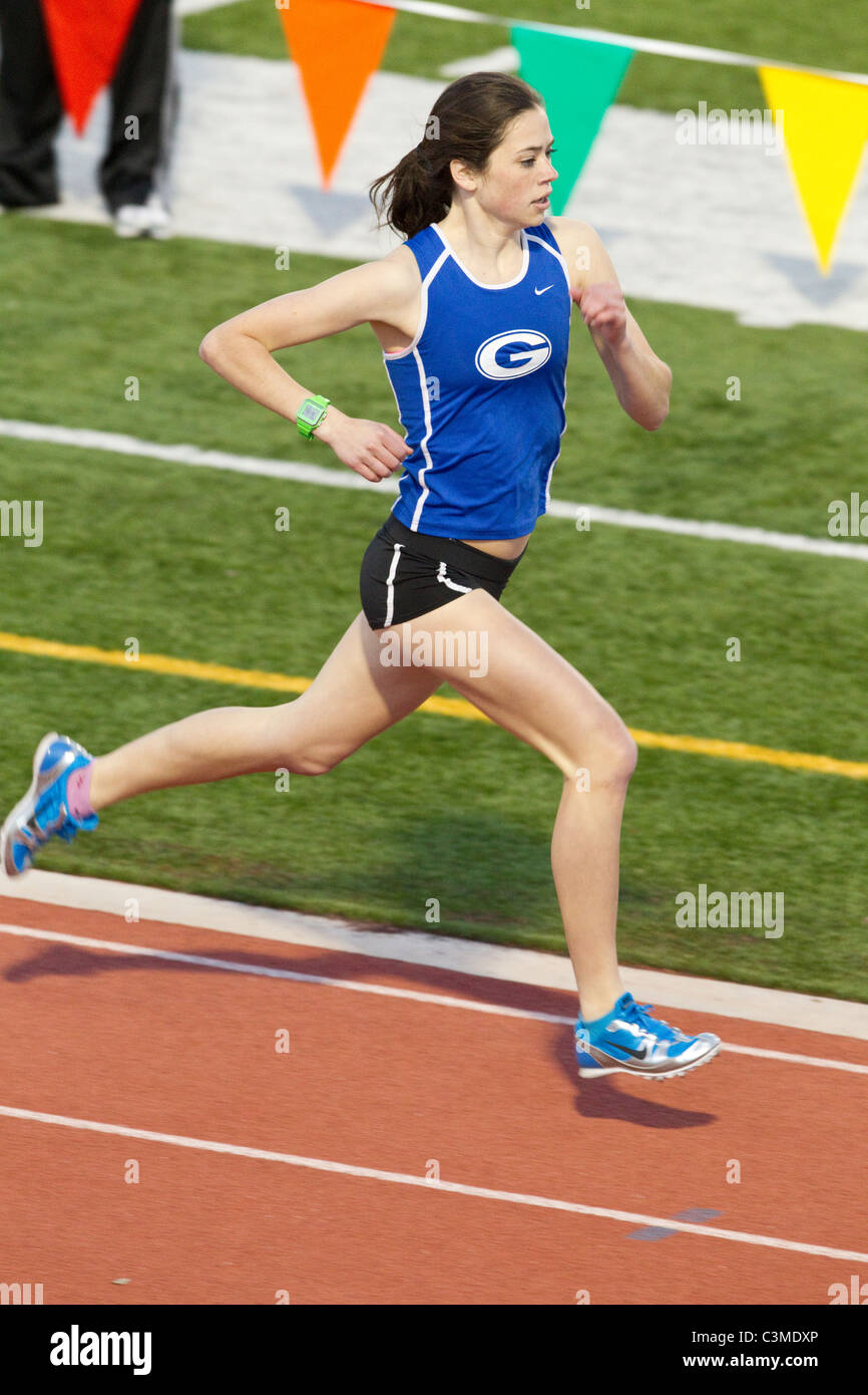 Anglo Female Athlete Wearing Blue Uniform Runs In High School Track Meet In San Antonio Texas anglo-female-athlete-wearing-blue-uniform-runs-in-high-school-track-meet-in-san-antonio-texas