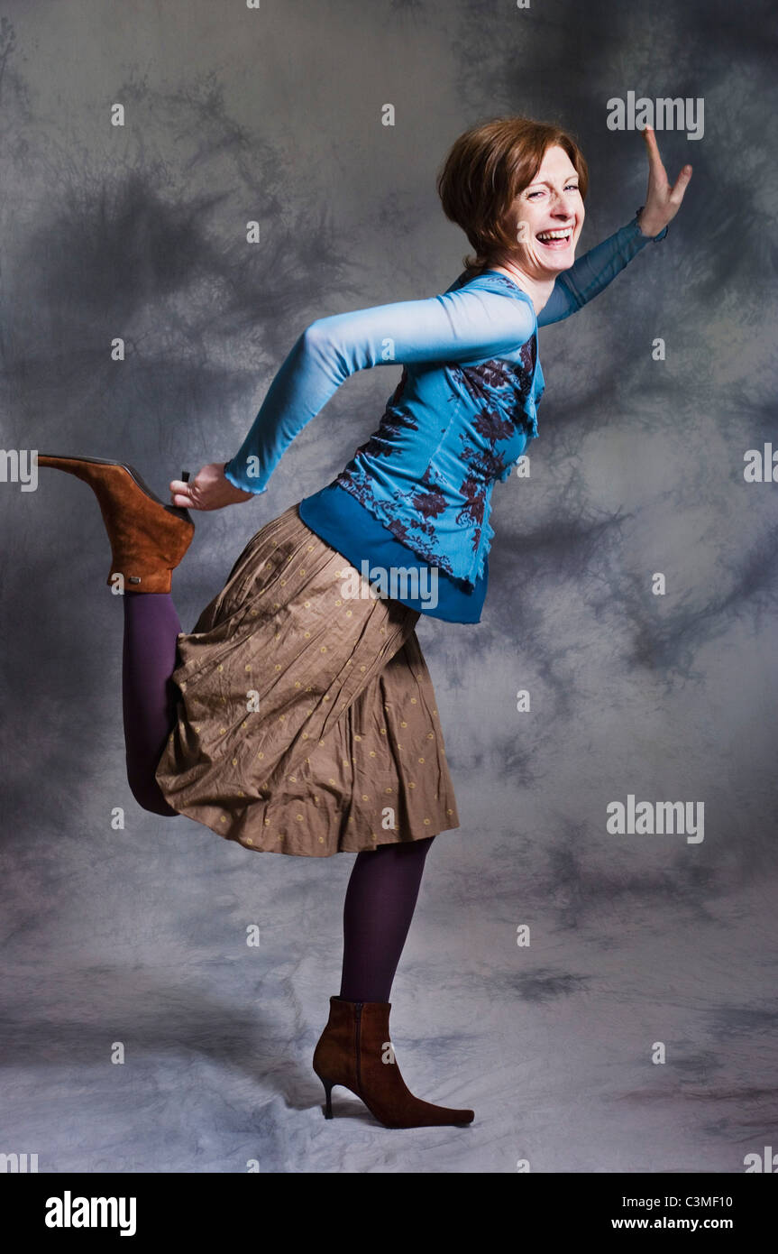 Mid adult woman standing and posing, smiling Stock Photo - Alamy