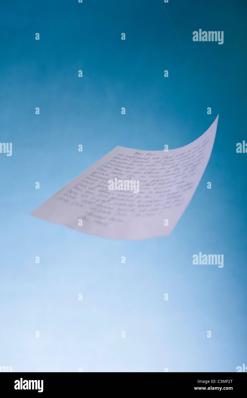 Love letter falling against blue background Stock Photo - Alamy