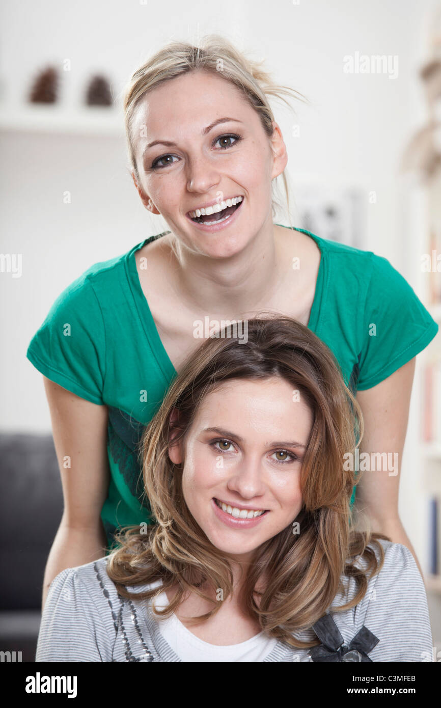 Germany, Munich, Young friends at home, smiling, portrait Stock Photo ...