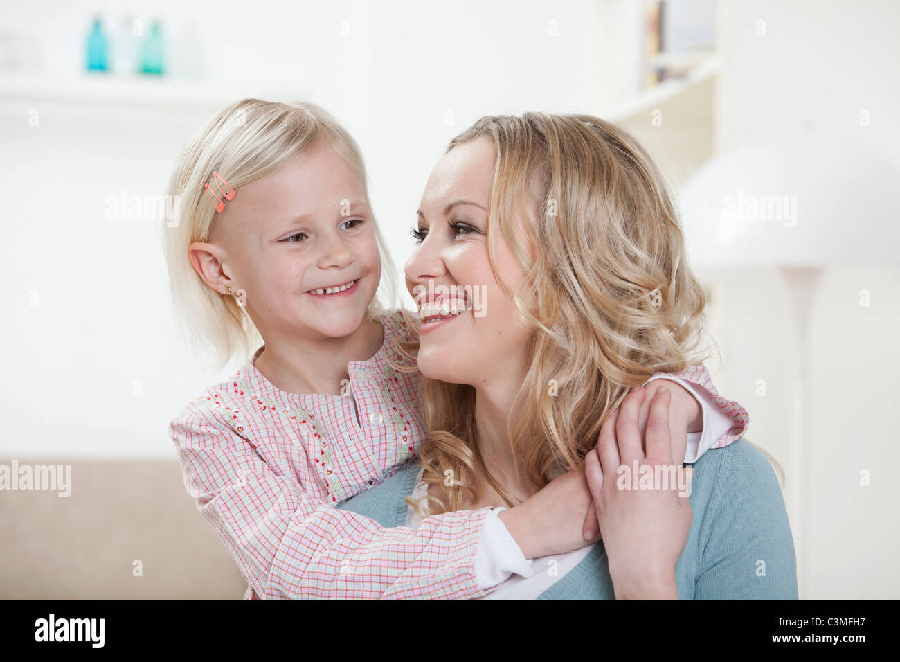Germany, Bavaria, Munich, Daughter embracing mother, laughing Stock ...