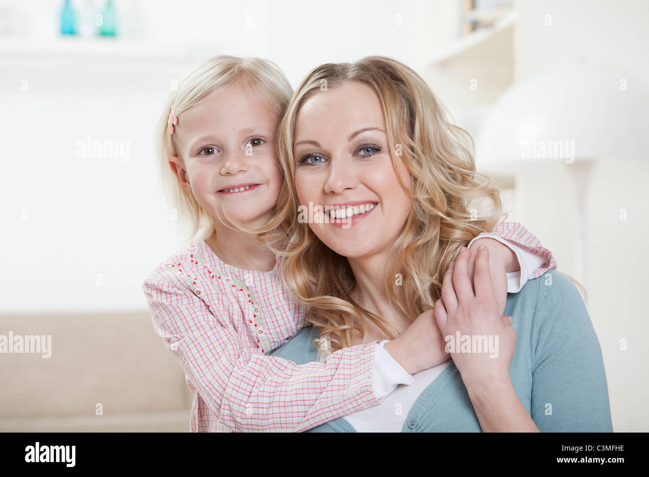 Germany, Bavaria, Munich, Daughter embracing mother, portrait, smiling ...
