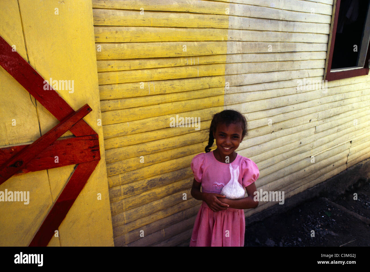 Dominican Republic Child Smiling By Coloured Building Stock Photo - Alamy