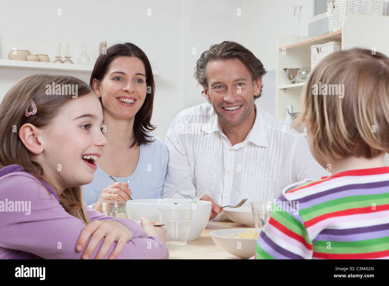 Germany, Bavaria, Munich, Family having lunch, smiling Stock Photo - Alamy