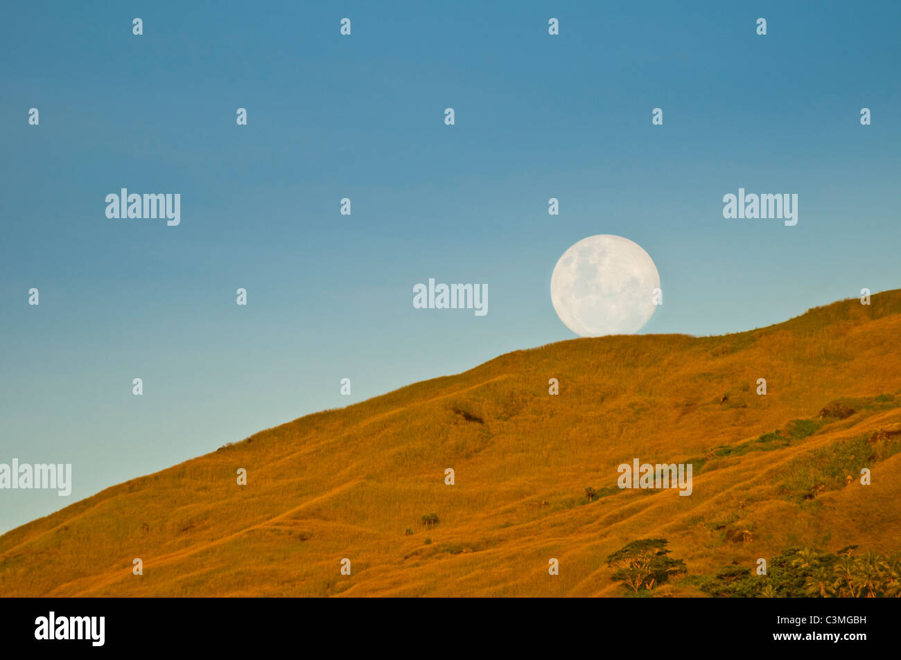 Full moon rising over the Mountains of Yawasa Islands, Fiji Stock Photo ...