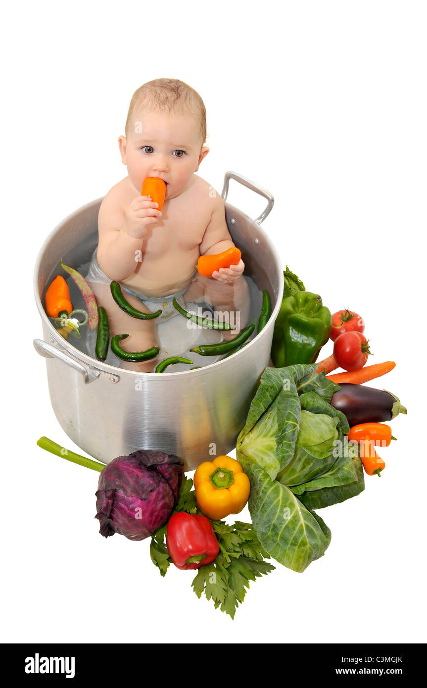 Beautiful young baby in a pan with vegetables Stock Photo - Alamy