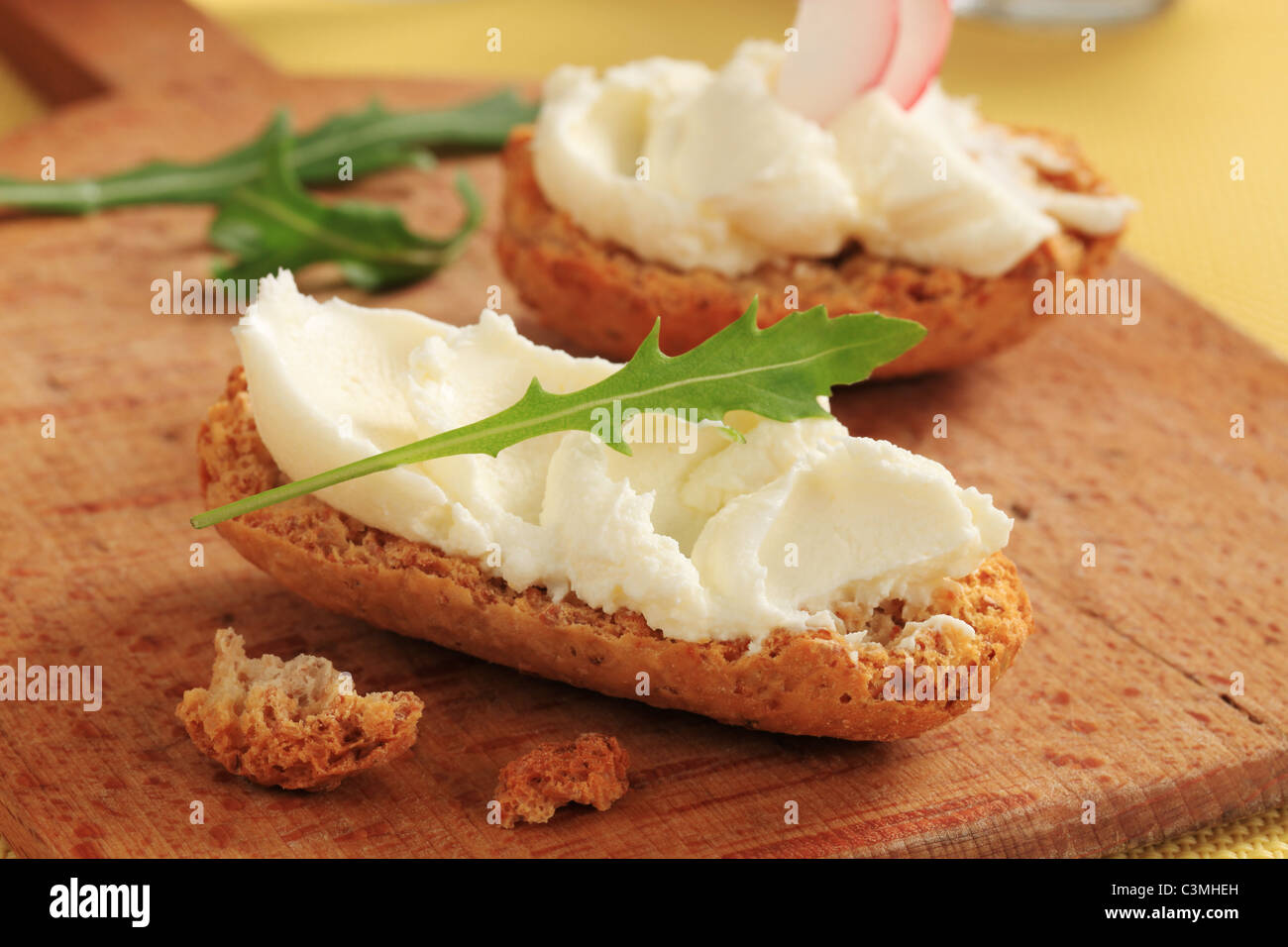 Crispy roll and cheese spread - closeup Stock Photo - Alamy