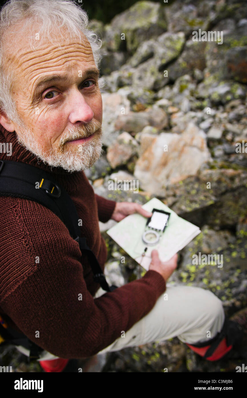 A portrait of a man using a map and compass Stock Photo - Alamy