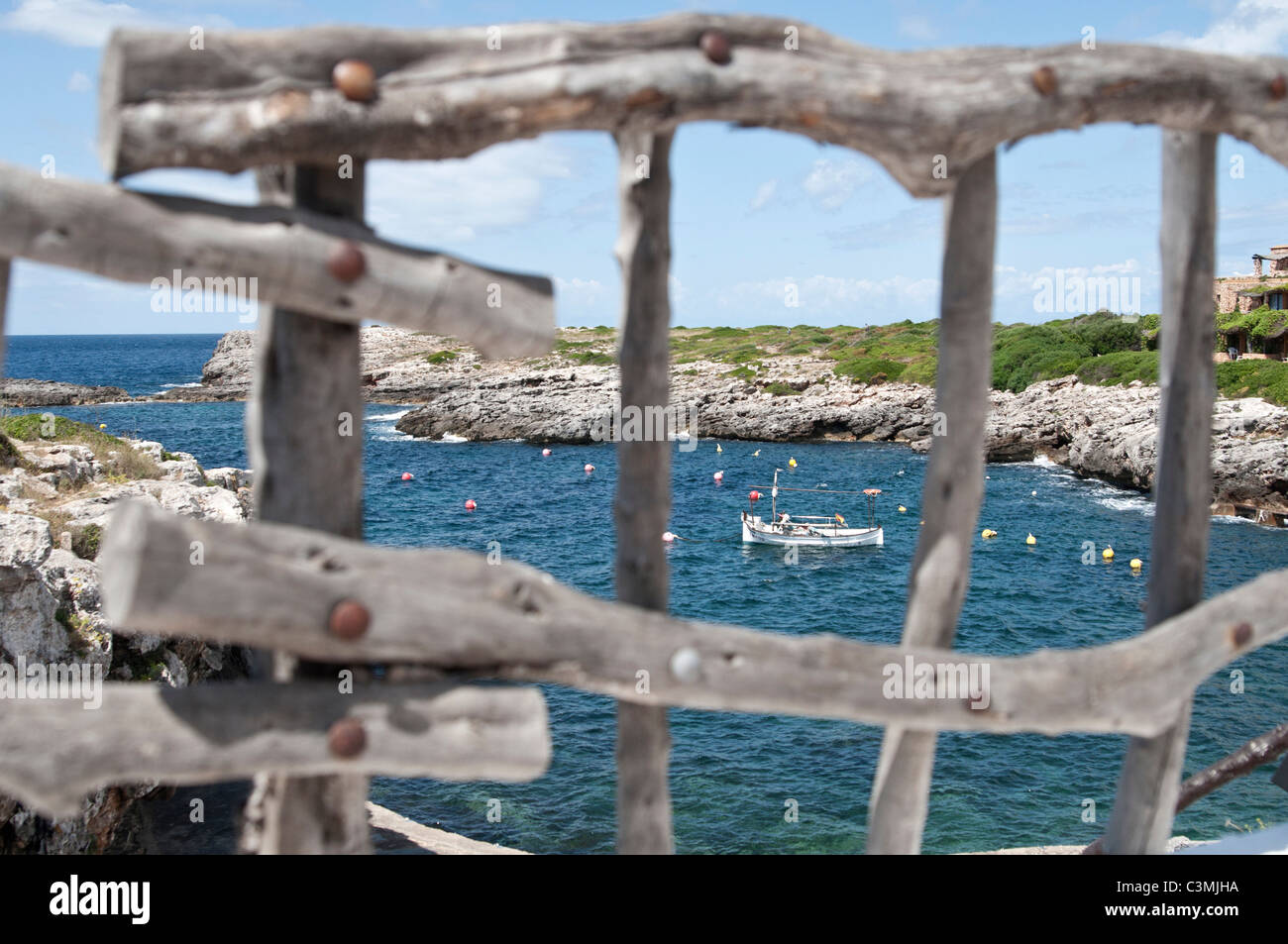 Spain, Balears, Menorca, View of boat in sea from wooden fence Stock ...