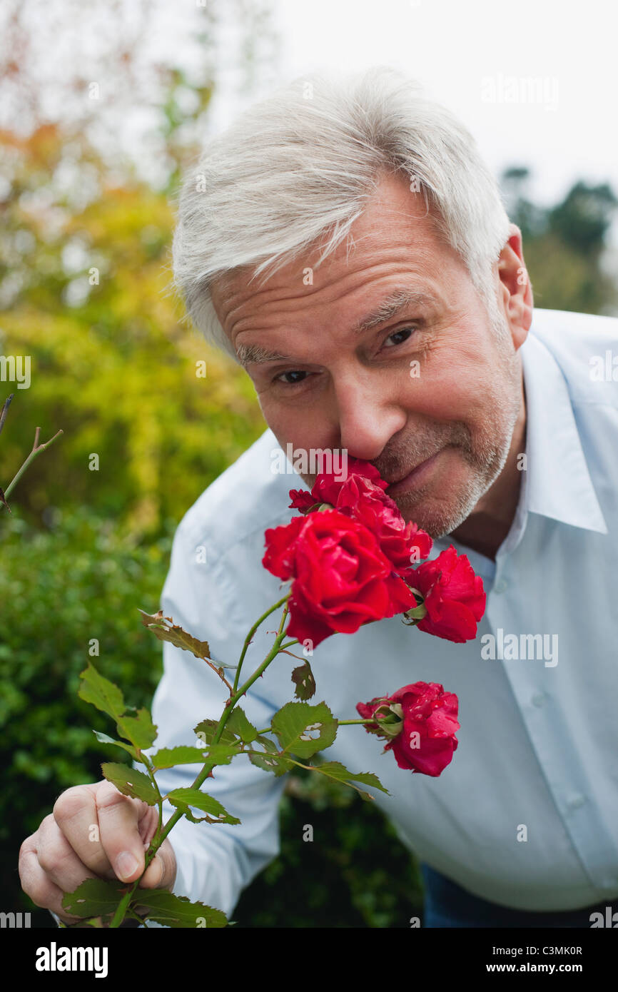 Senior man smelling roses hi-res stock photography and images - Alamy
