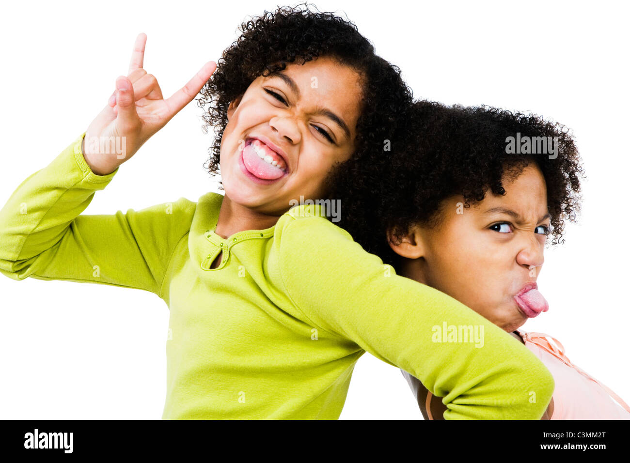 Portrait of two girls making face isolated over white Stock Photo - Alamy