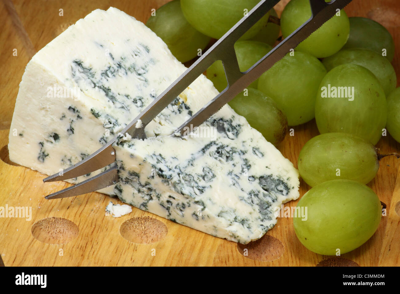 Delicious cheese with green grapes Stock Photo - Alamy