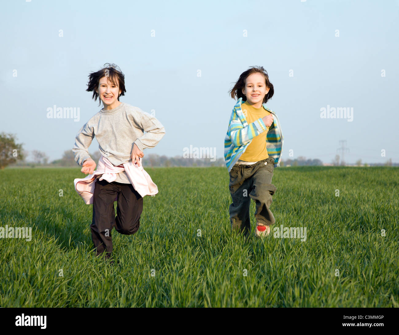 run of little girls on the spring field Stock Photo - Alamy
