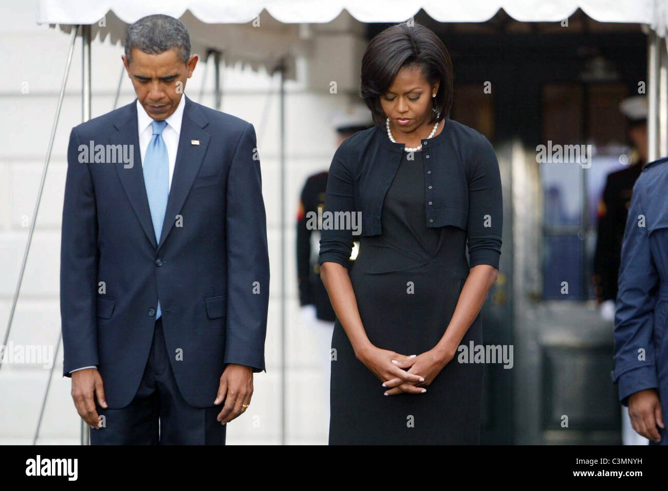 US President Barack Obama and First Lady Michelle Obama observe a ...