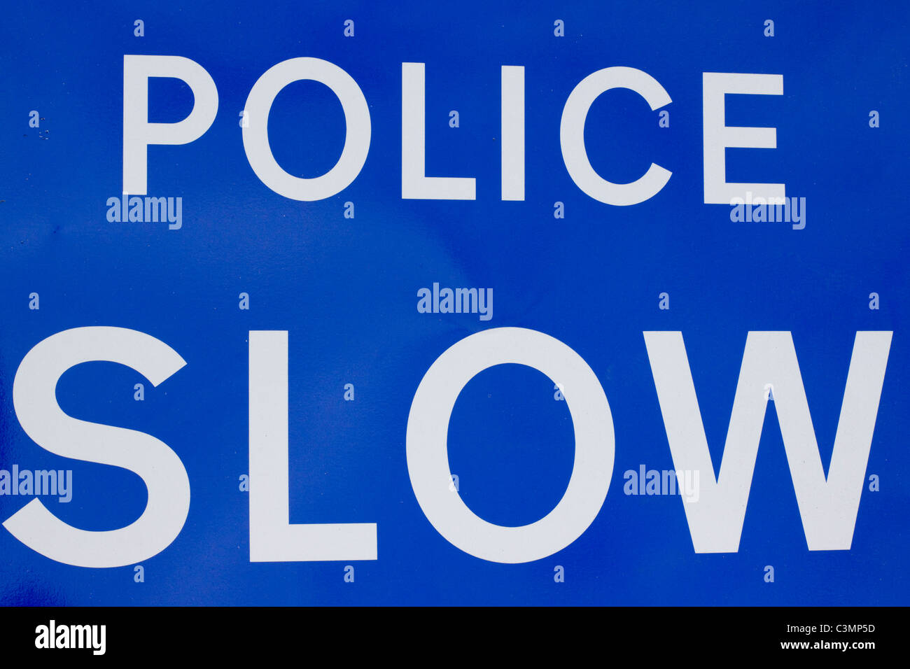 Police Slow Sign on the road side Stock Photo - Alamy
