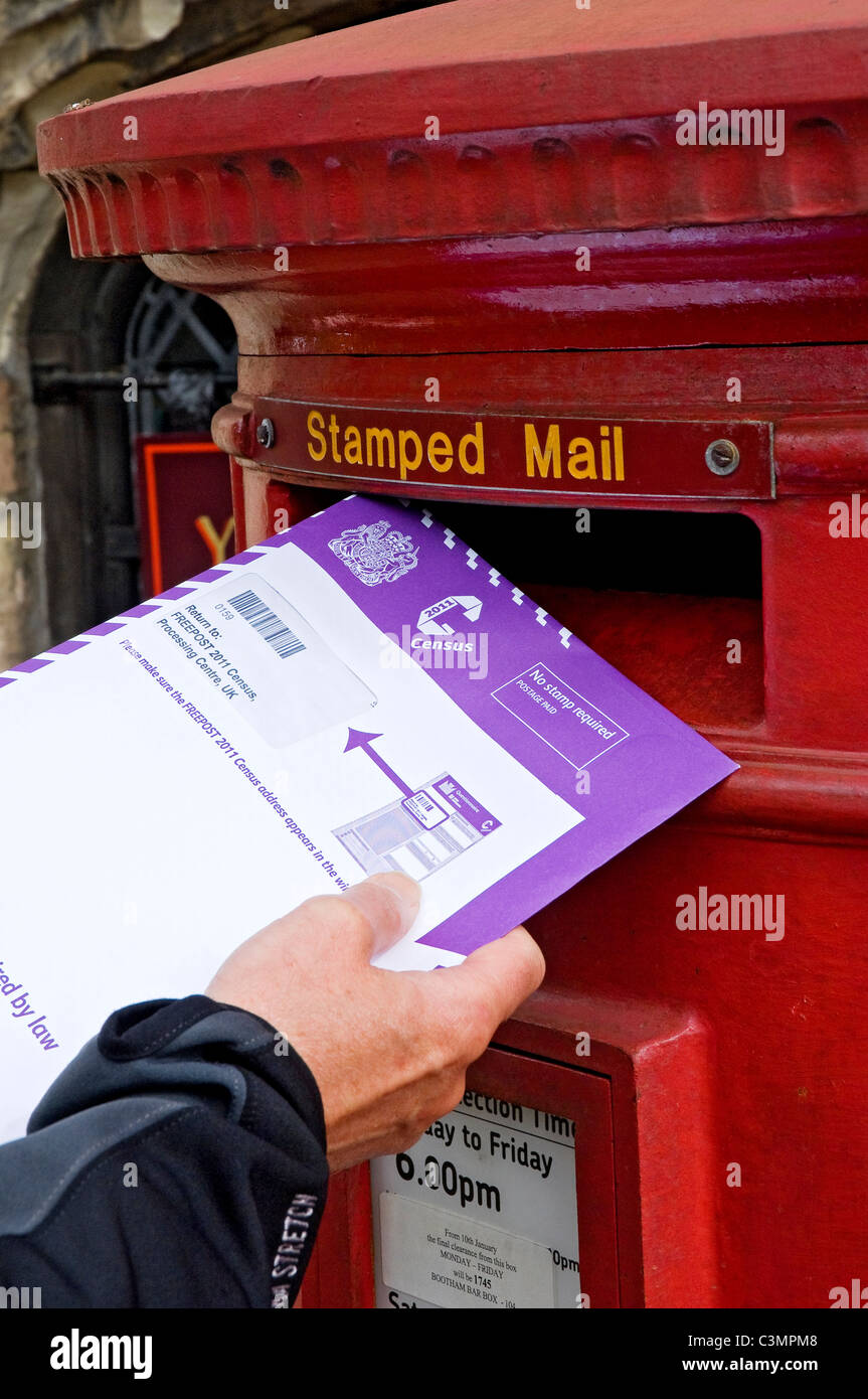 Close up of person man posting completed 2011 census survey form forms ...