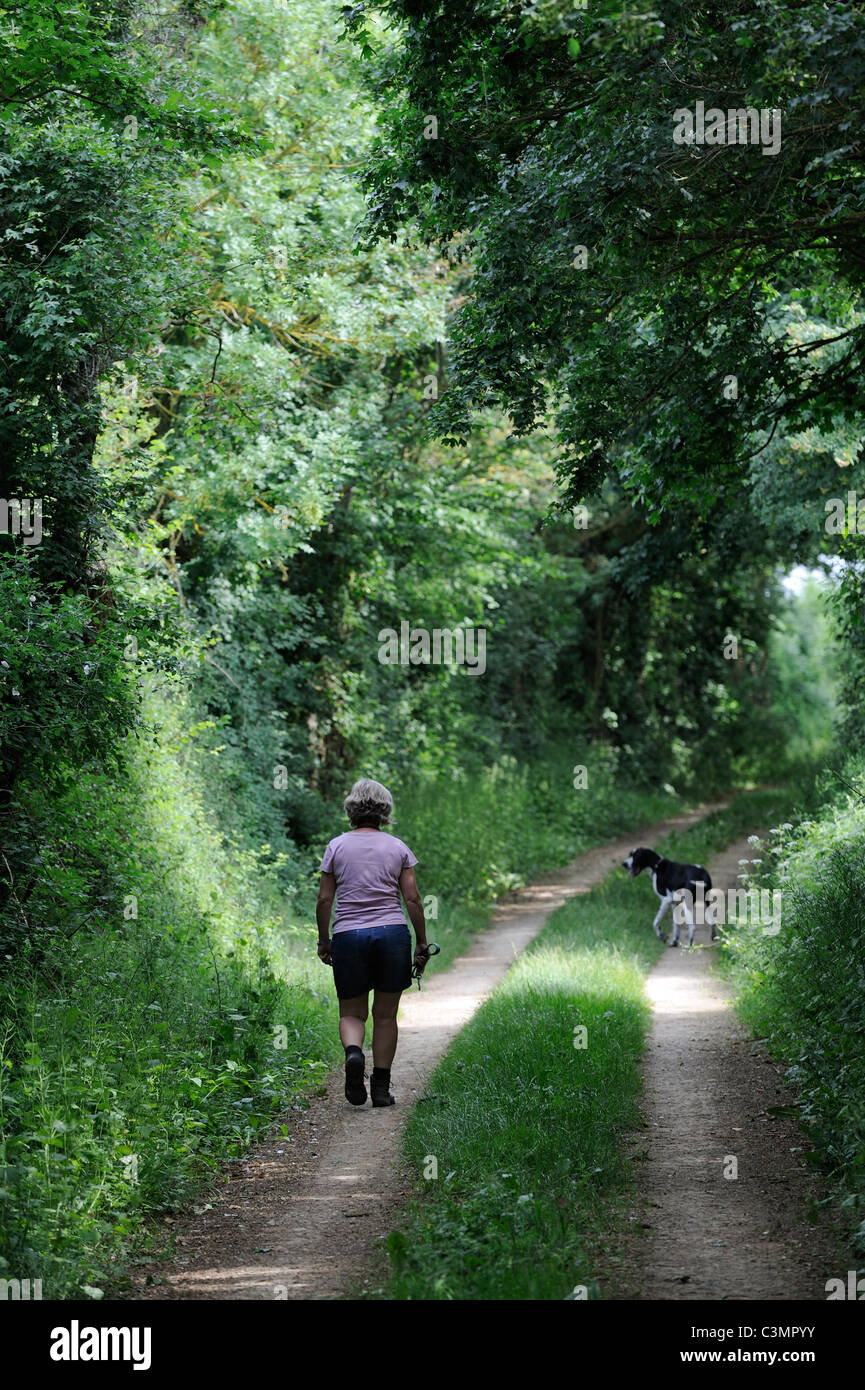 Woman walking down country lane hi-res stock photography and images - Alamy