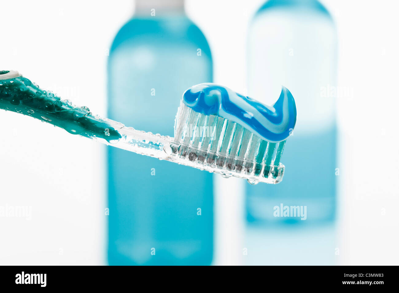 Close up of toothbrush and toothpaste with mouthwash bottle in ...