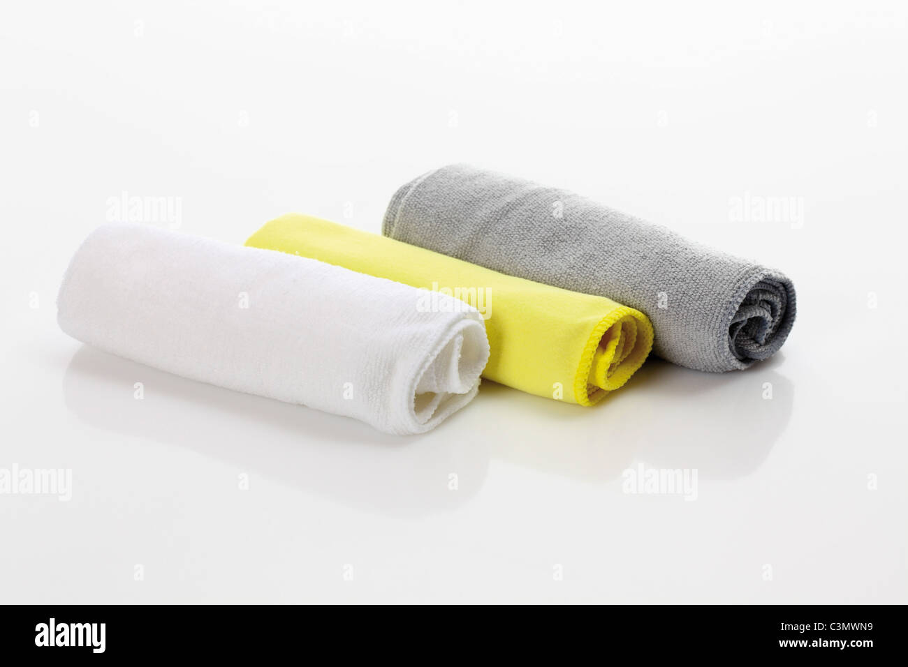 Rolled up microfibre clothes on white background Stock Photo - Alamy