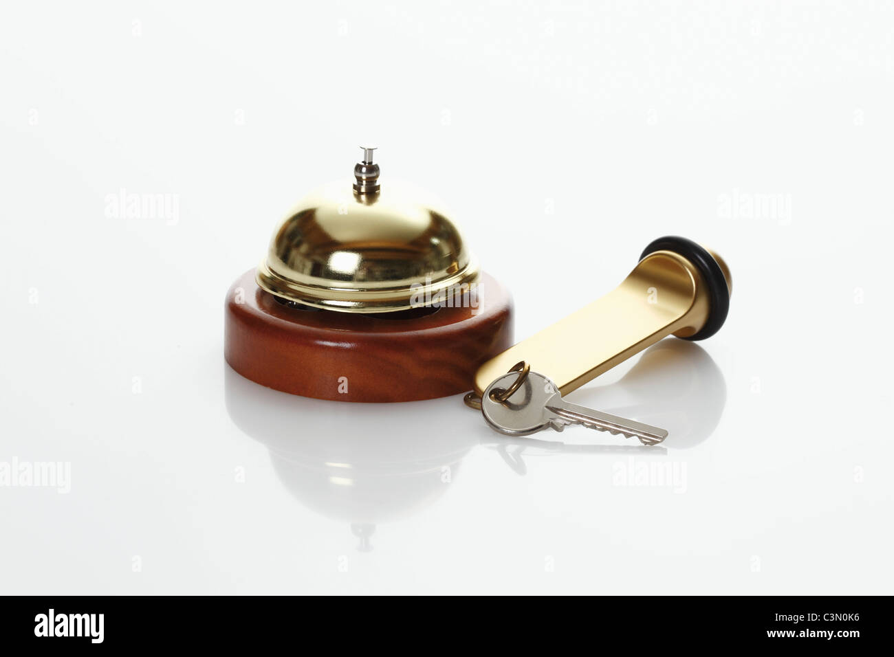 Hotel key and service bell on white background Stock Photo - Alamy