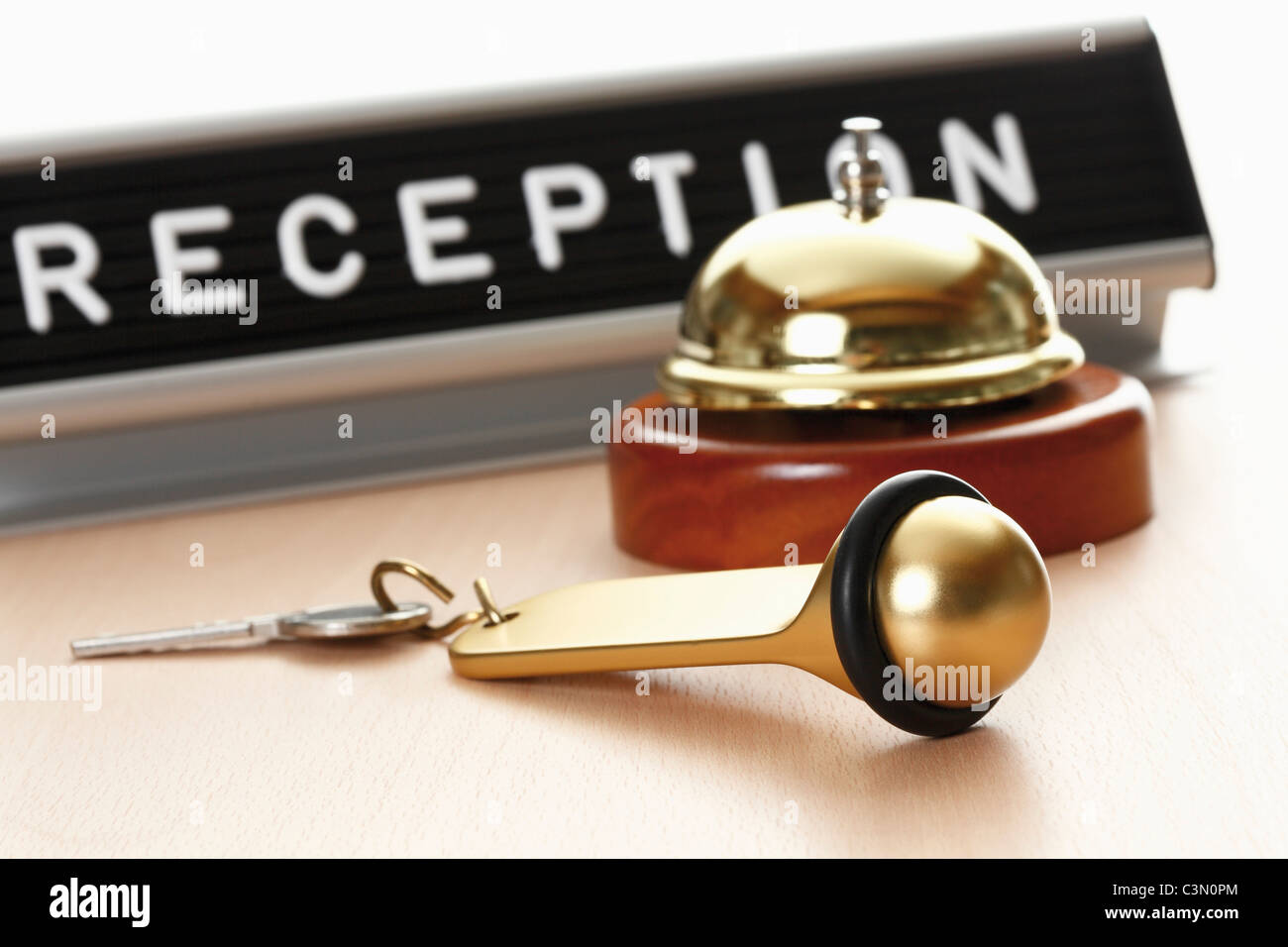 Reception sign with service bell and hotel key on desk Stock Photo - Alamy