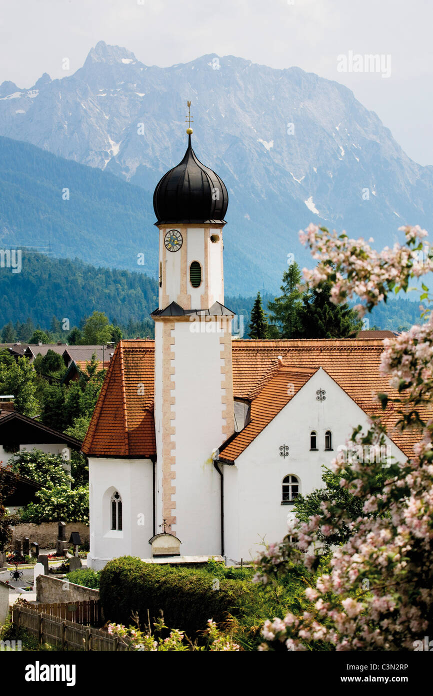 Germany, Bavaria, Wallgau, Catholic parish church with mountains in ...