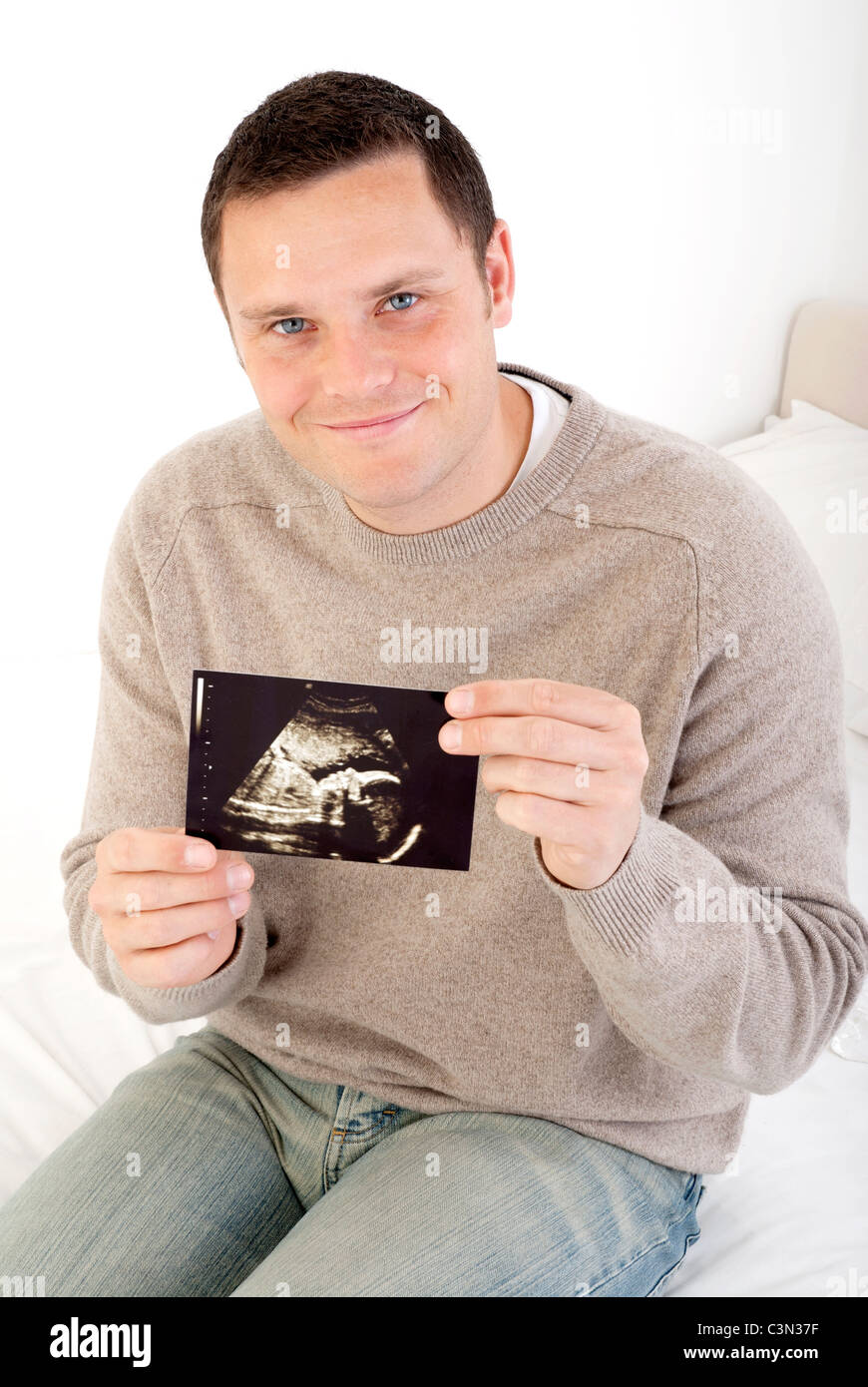 Man holding ultrasound scan to camera Stock Photo - Alamy
