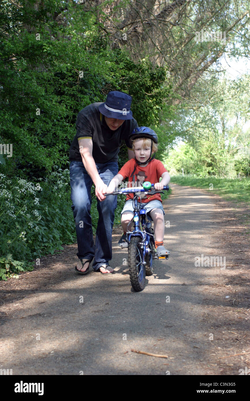 Young Boy Learning to ride his bike Stock Photo - Alamy