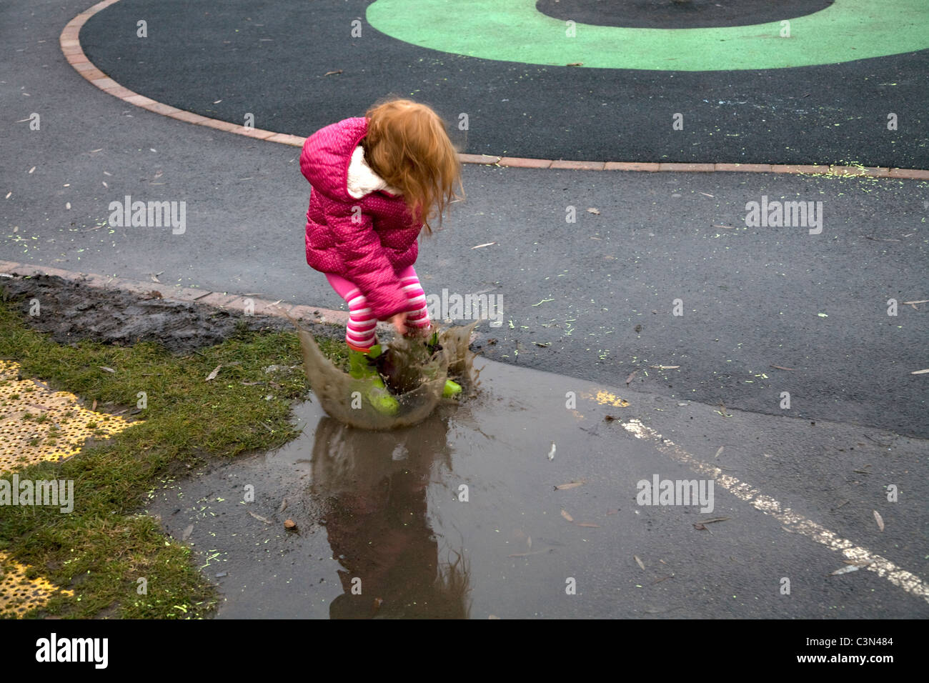 small girl jumping in puddle Stock Photo - Alamy