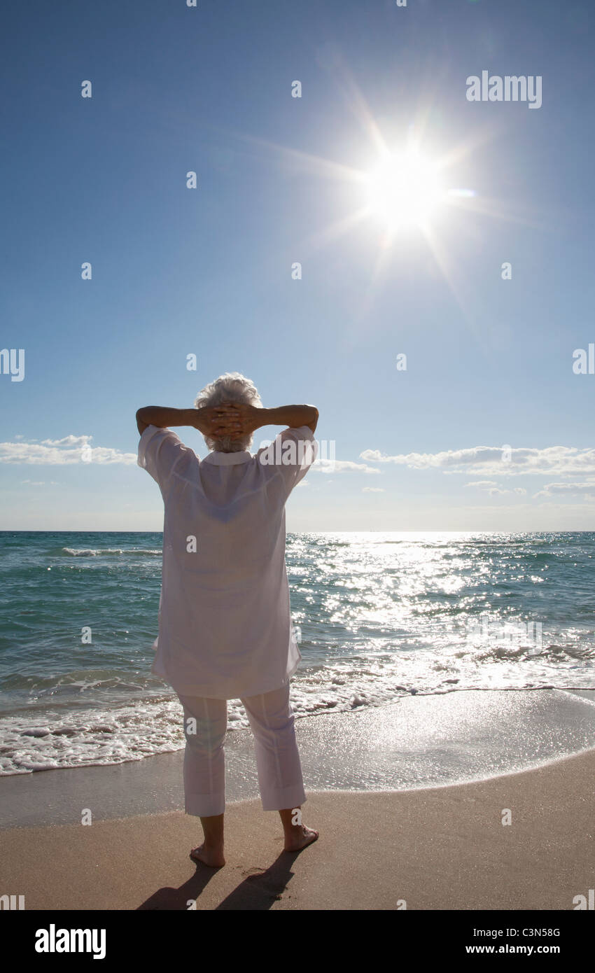 Woman arms behind head beach hi-res stock photography and images - Alamy
