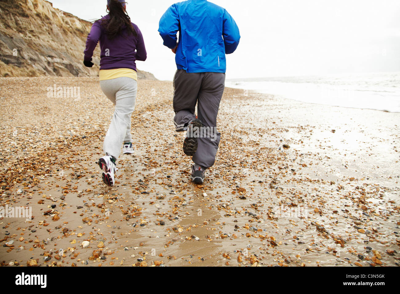 Couple jogging race on beach hi-res stock photography and images - Alamy
