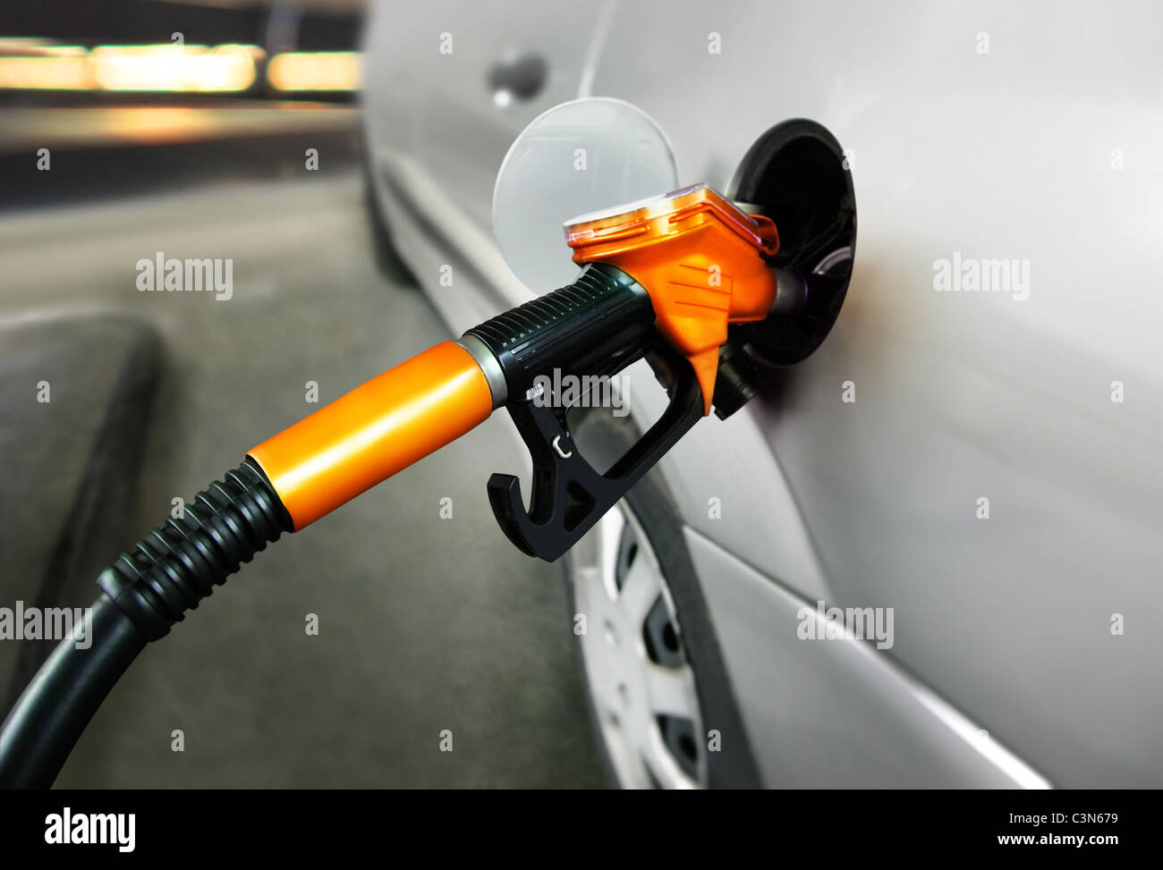 grey car at gas station being filled with fuel Stock Photo - Alamy
