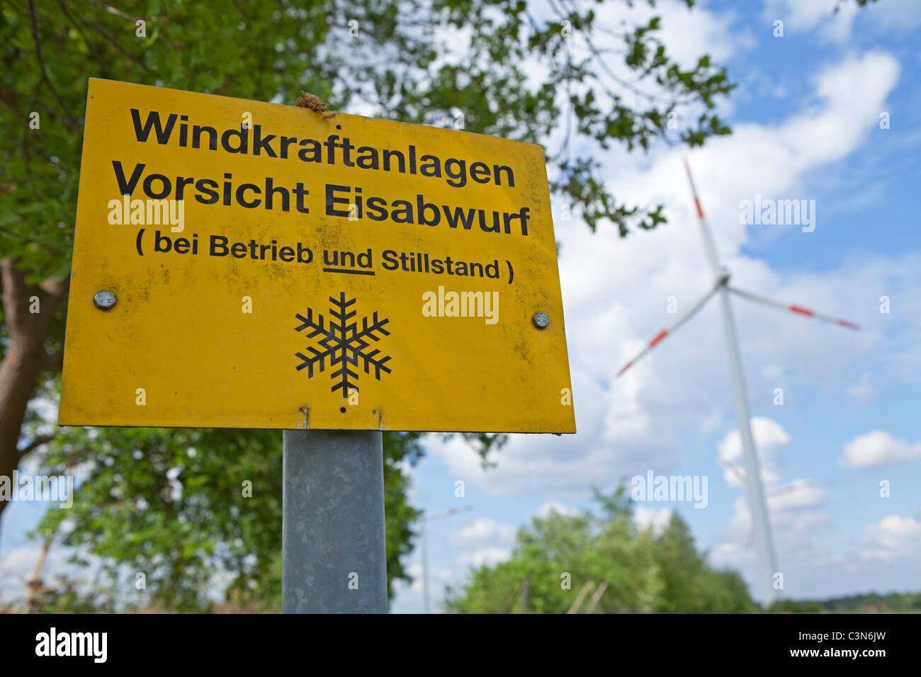 sign warning of falling ice beside a wind power station near Suelbeck ...