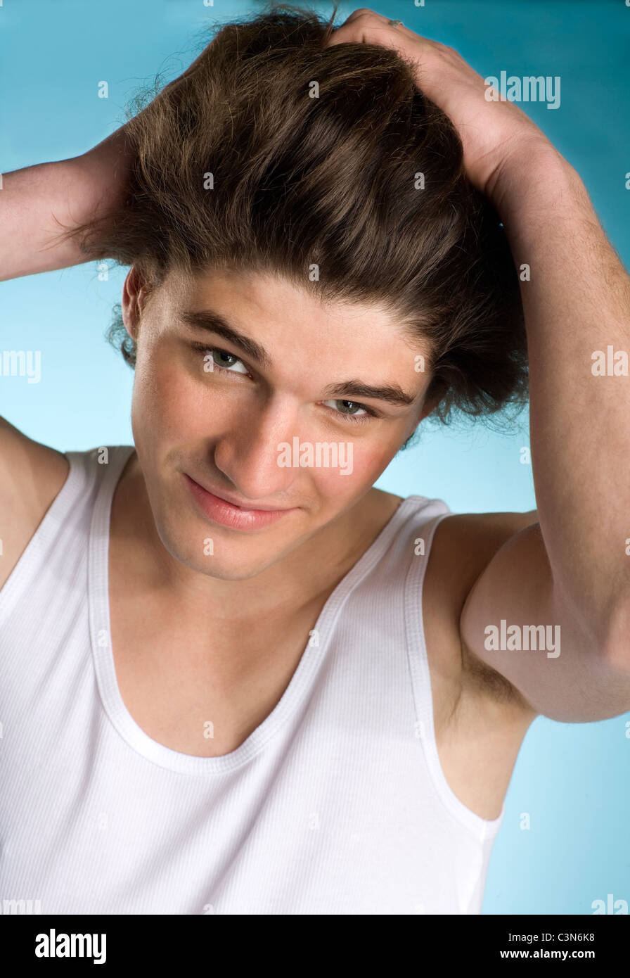 Young man hands to hair portrait Stock Photo - Alamy