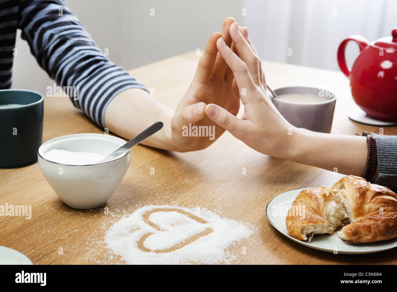 Two hands touching over table Stock Photo - Alamy