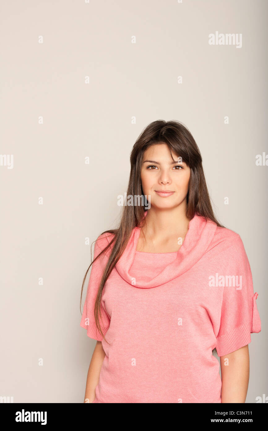 Young woman half smiling Stock Photo - Alamy