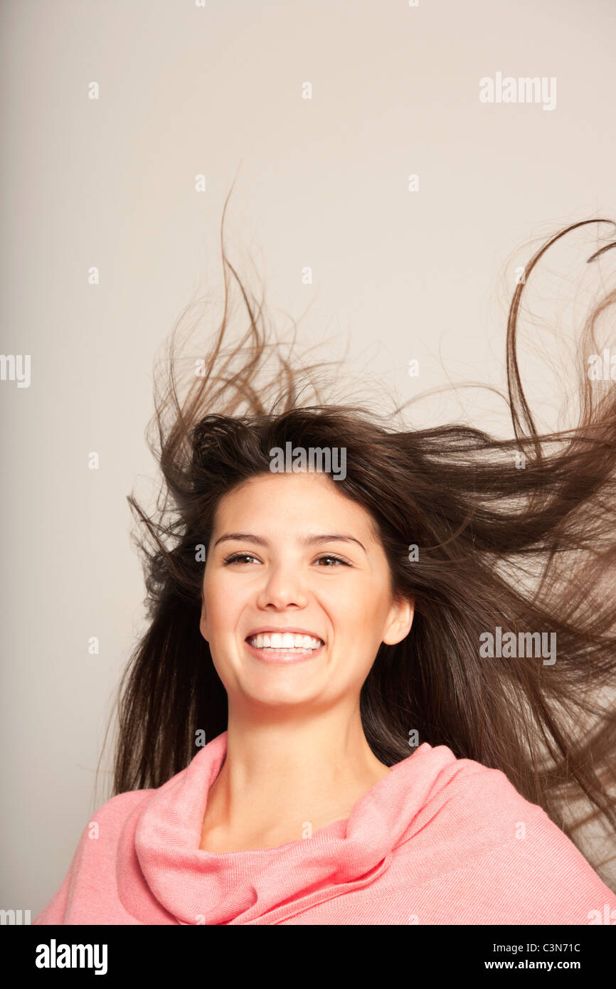 Headshot of a young woman hair flying Stock Photo - Alamy