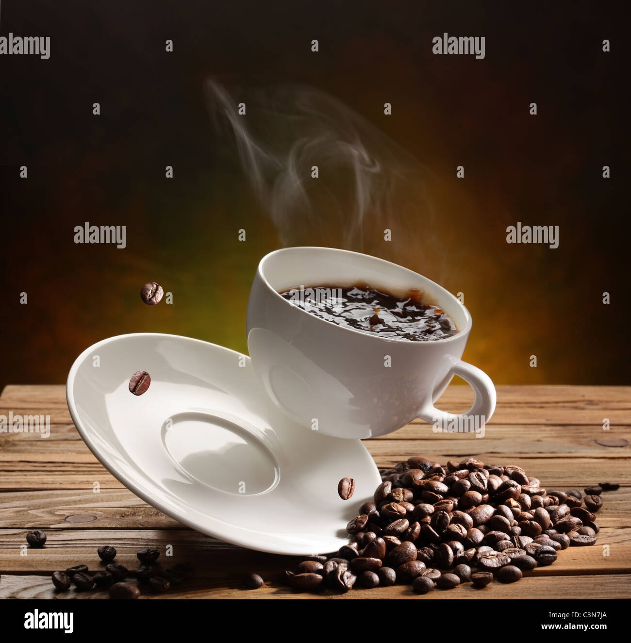 Falling coffee cup on the table Stock Photo - Alamy